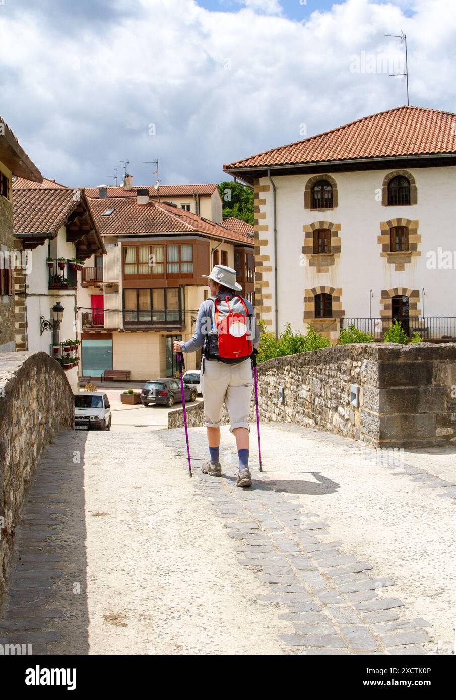 Woman pilgrim crossing the bridge into the Spanish village of Zubiri ...