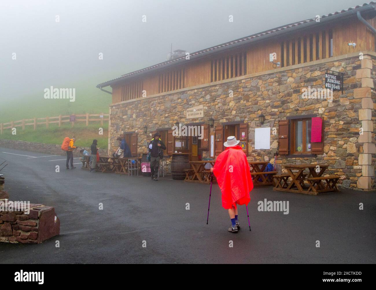 Pilgrims walking the Camino de Santiago the way of St James in wet ...