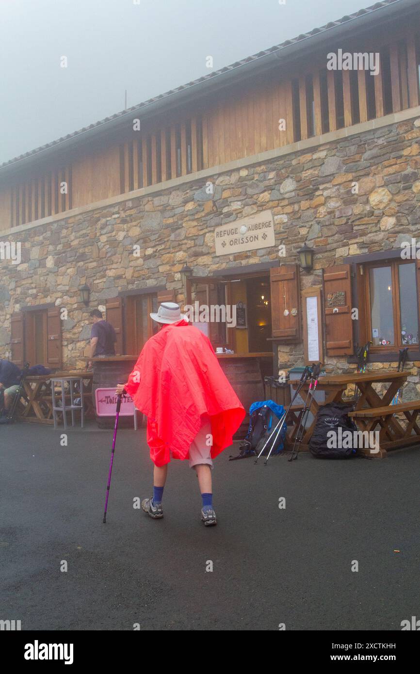 Pilgrims walking the Camino de Santiago the way of St James in wet ...