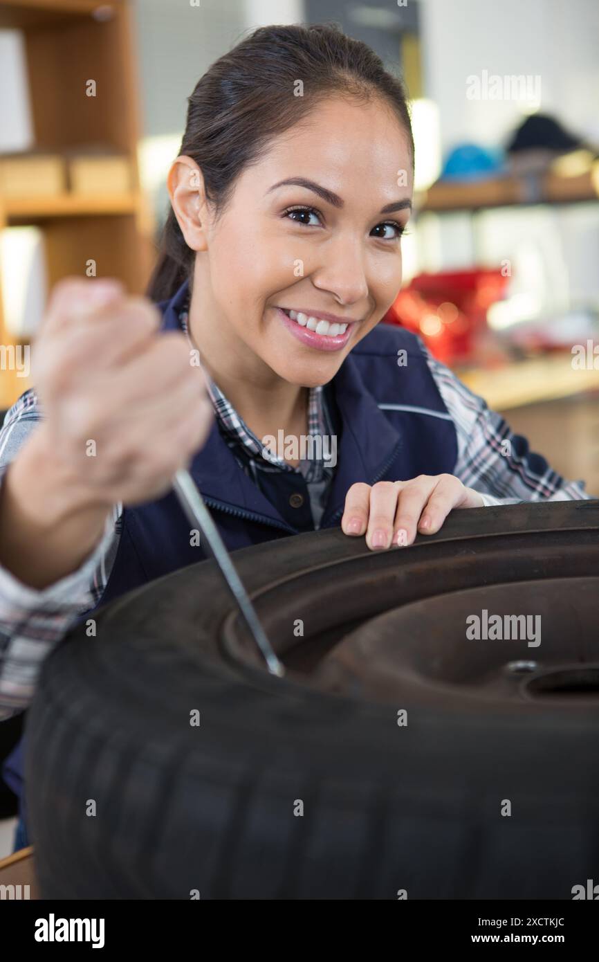 female mechanic repairing car wheel Stock Photo - Alamy