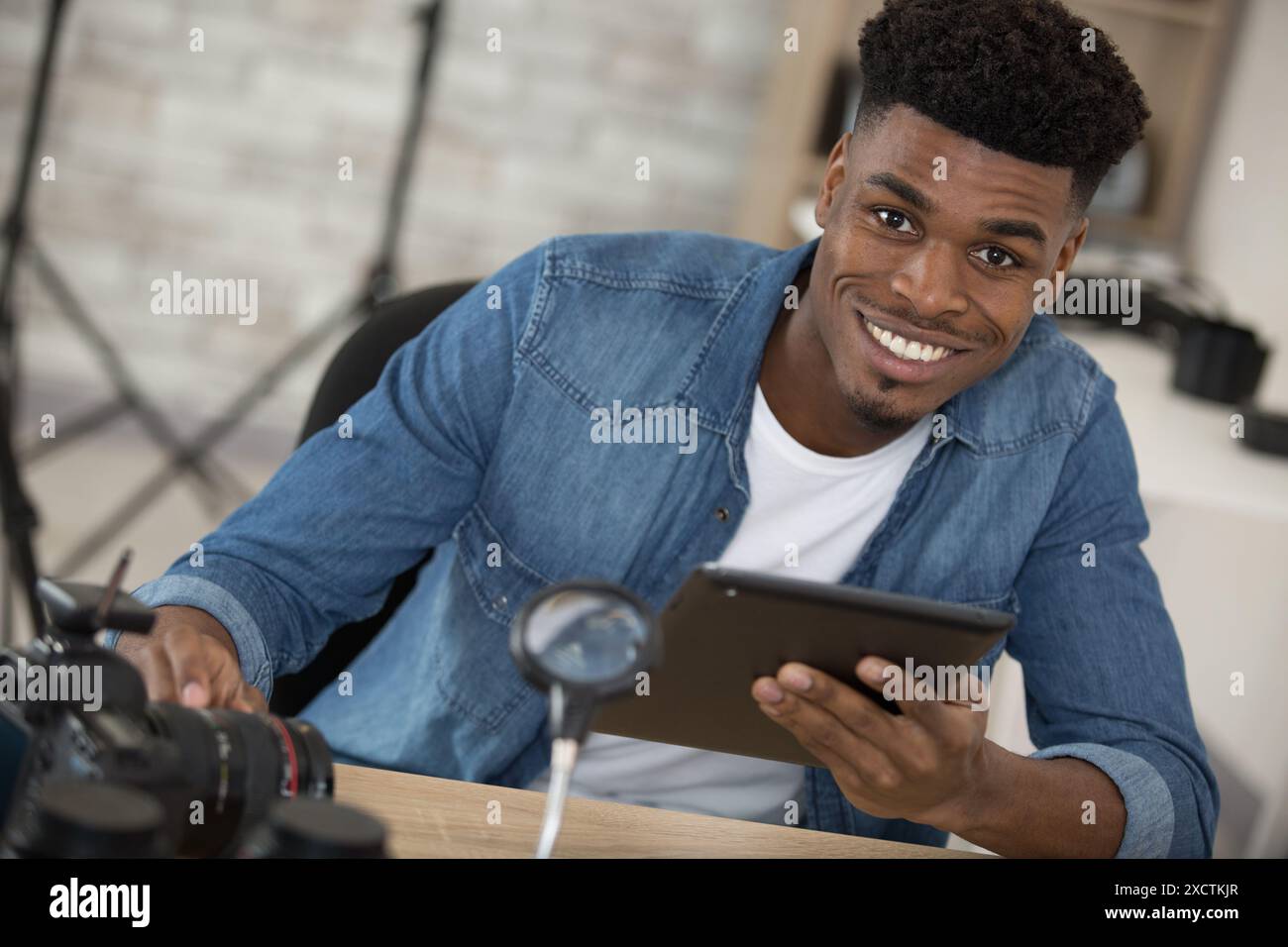 young photographer retouching on his tablet Stock Photo - Alamy