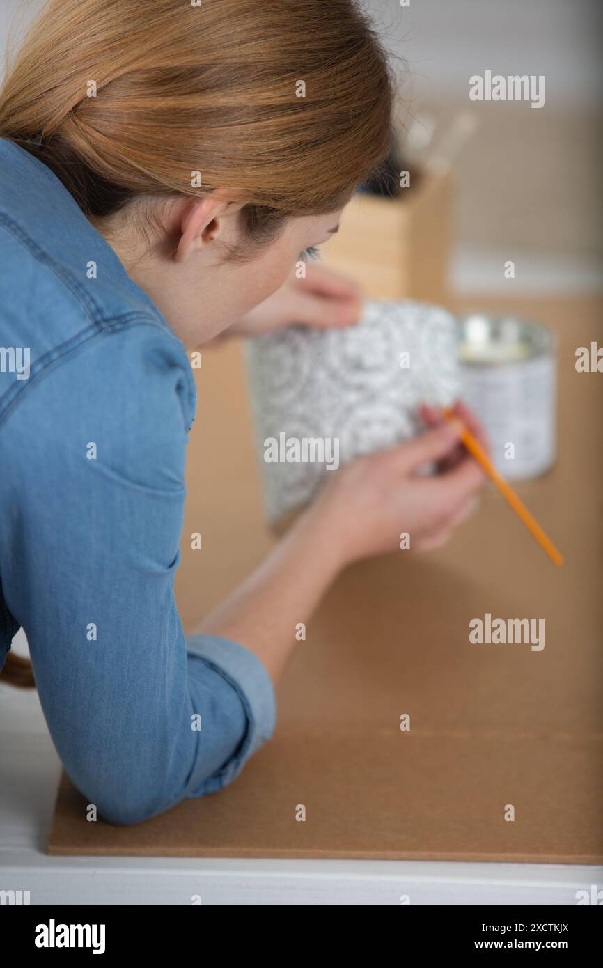 young woman finishing plate manufacturing Stock Photo - Alamy