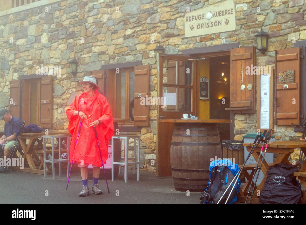 Pilgrims walking the Camino de Santiago the way of St James in wet ...