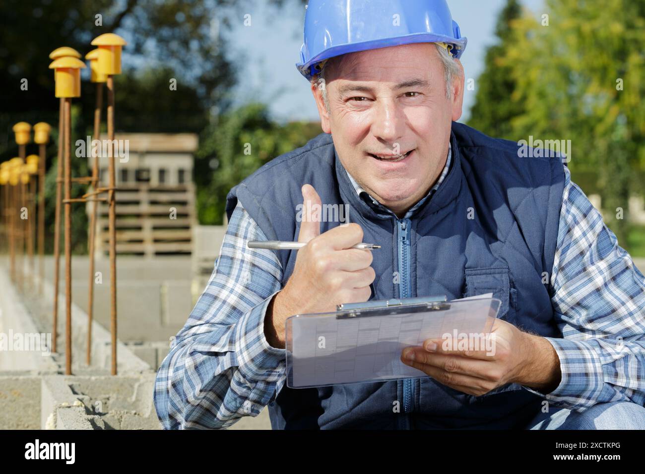 handsome happy workman showing thumb up isolated on white Stock Photo ...