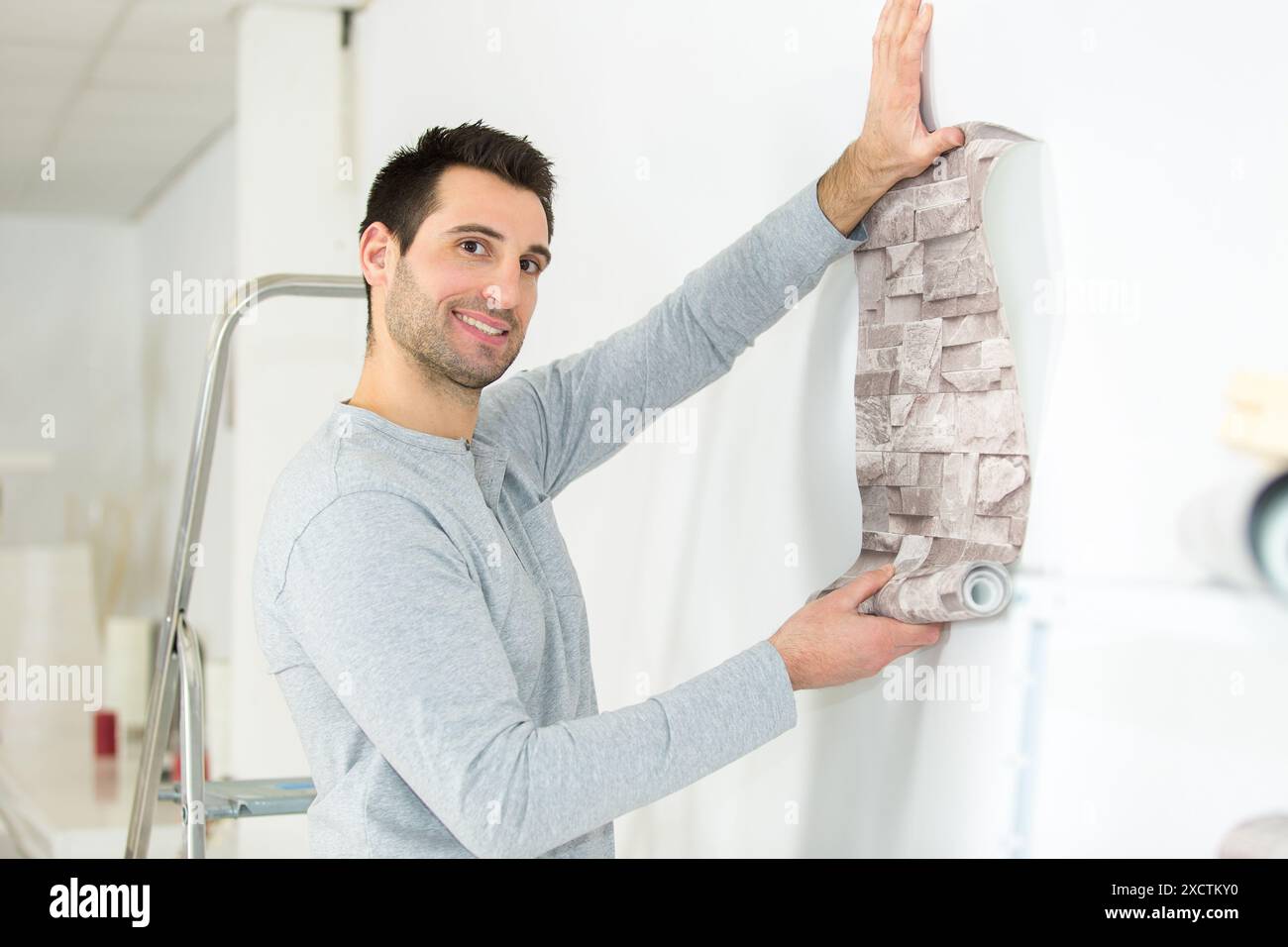 Putting wall paper hi-res stock photography and images - Alamy