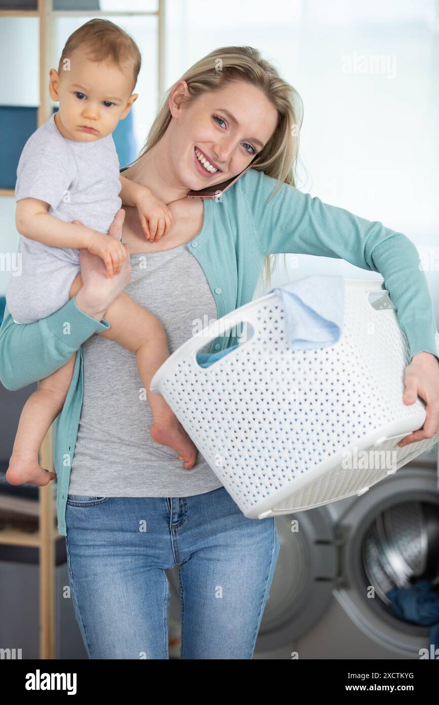 mom and baby doing the laundry Stock Photo - Alamy