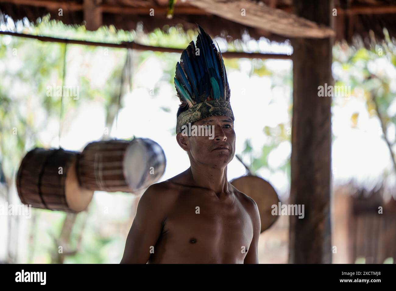 Wayuri indigenous man poses proudly in front of his traditional drums ...