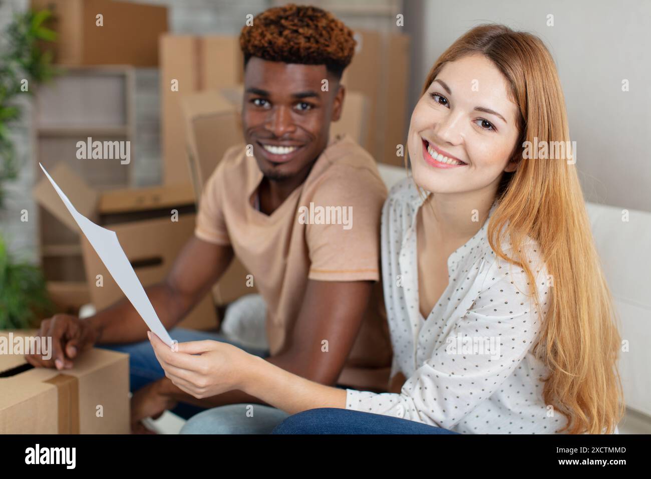mixed couple open cardboard box or parcel unpacking Stock Photo - Alamy