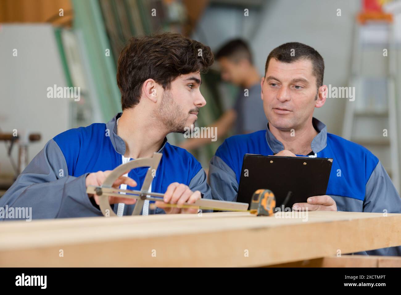 industrial carpentry trainer asking question Stock Photo - Alamy