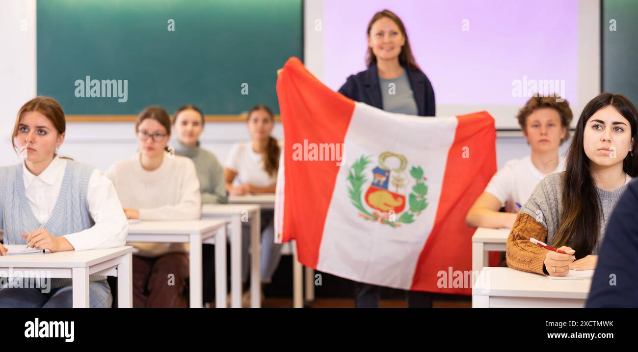 Female professor stands near students with flag of Peru Stock Photo - Alamy