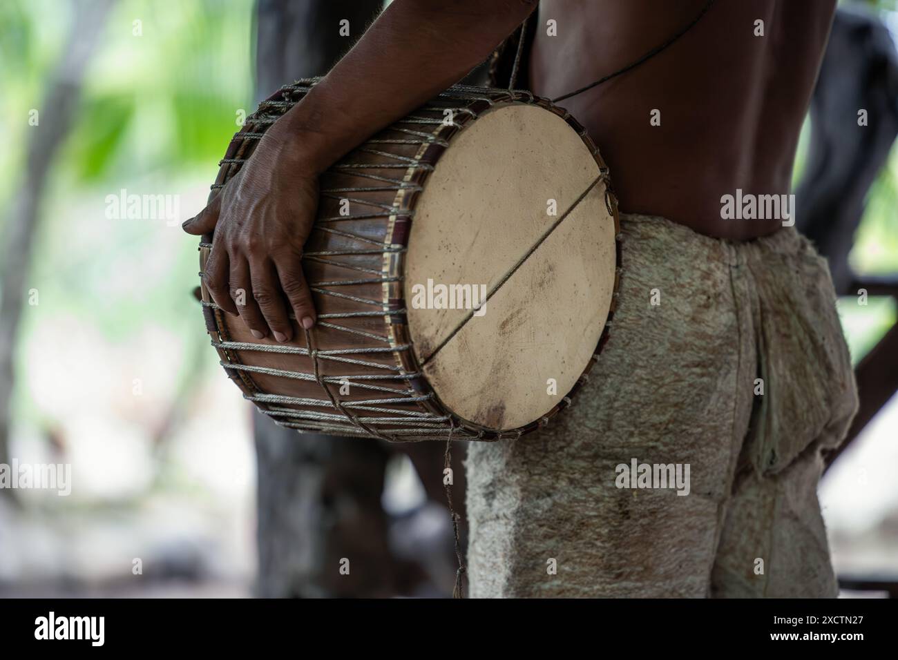 closeup of a Wayuri indigenous community member playing a traditional ...