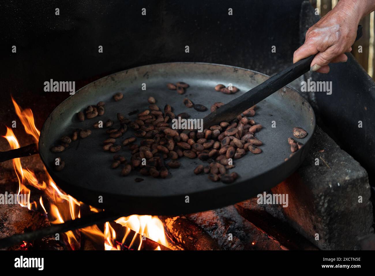 closeup In a traditional setting, an Ecuadorian man's hand skillfully ...