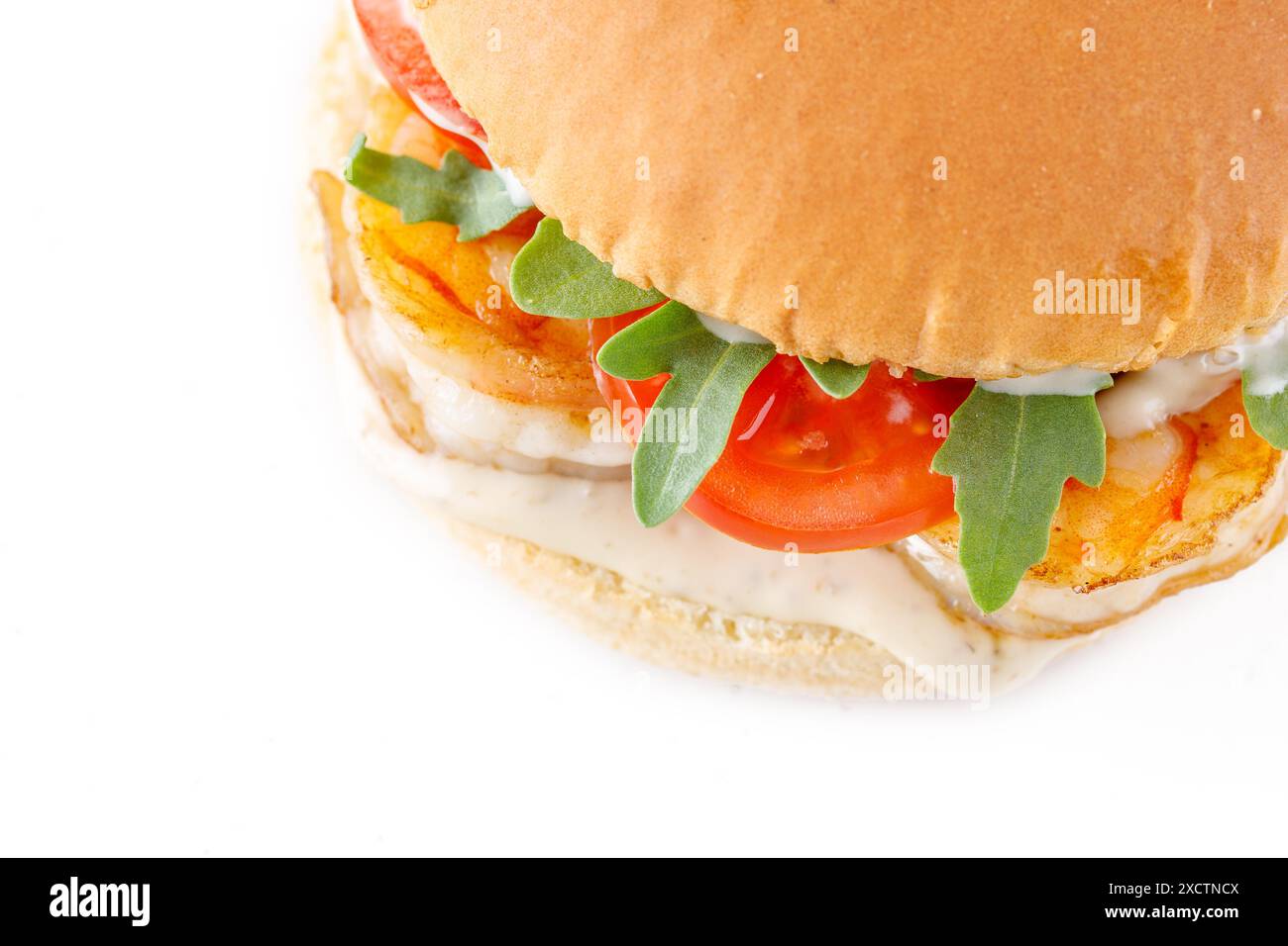 Close-up of burger with shrimps and meat served on folded black napkin ...