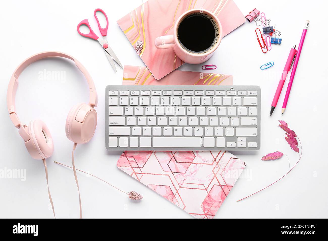 Composition with modern computer keyboard, cup of coffee, headphones and stationery on white ...