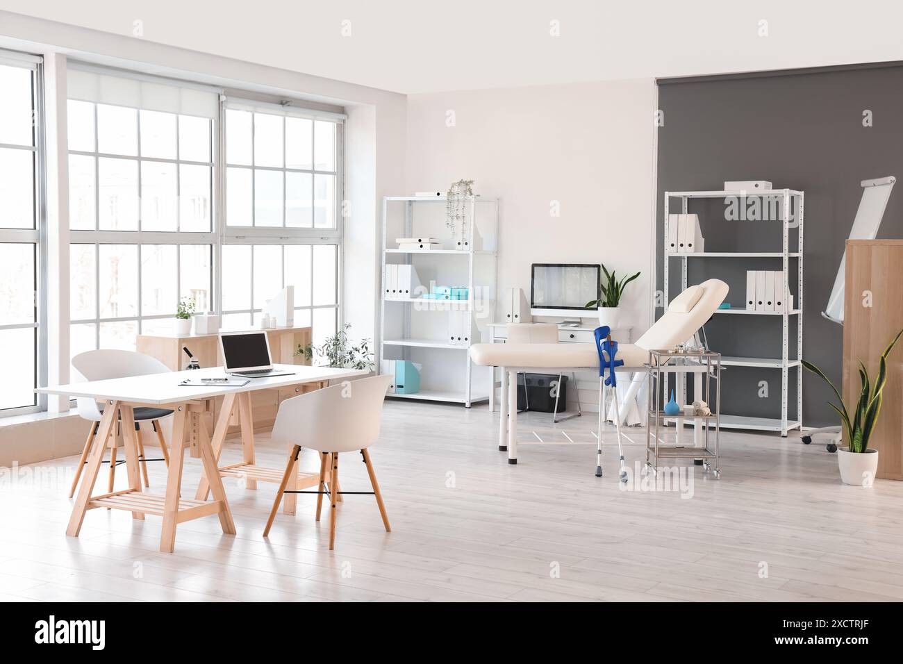 Interior of medical office with tables, couch and shelf units Stock ...