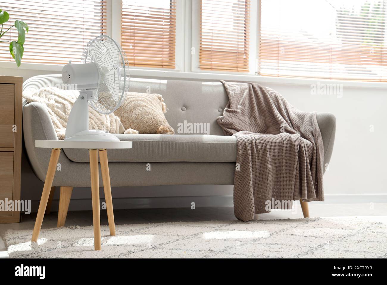 Electric fan on table in living room interior Stock Photo - Alamy