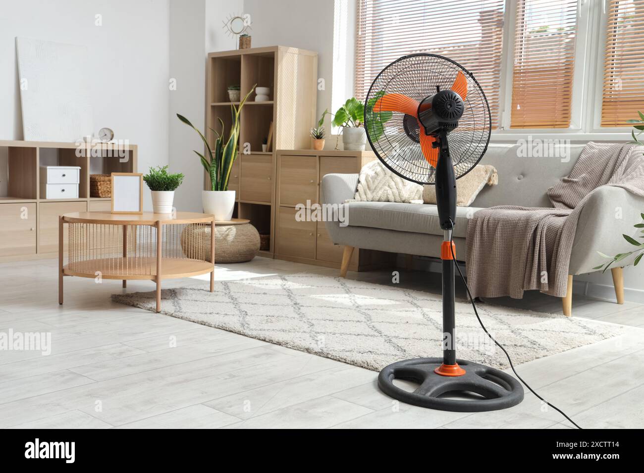 Electric fan in modern living room interior Stock Photo - Alamy
