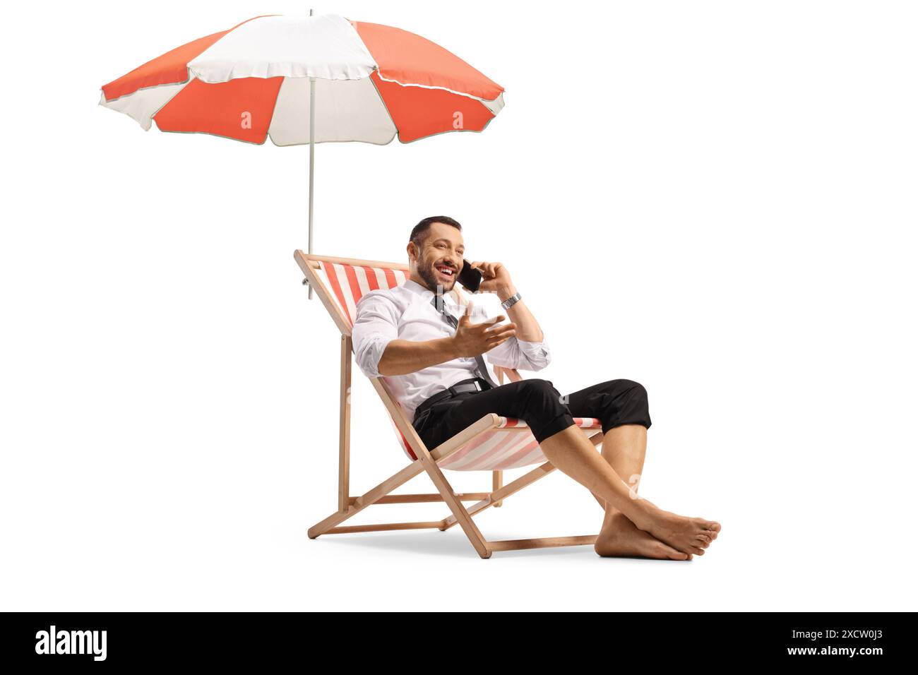 Businessman sitting on a beach chair under umbrella and making a phone ...