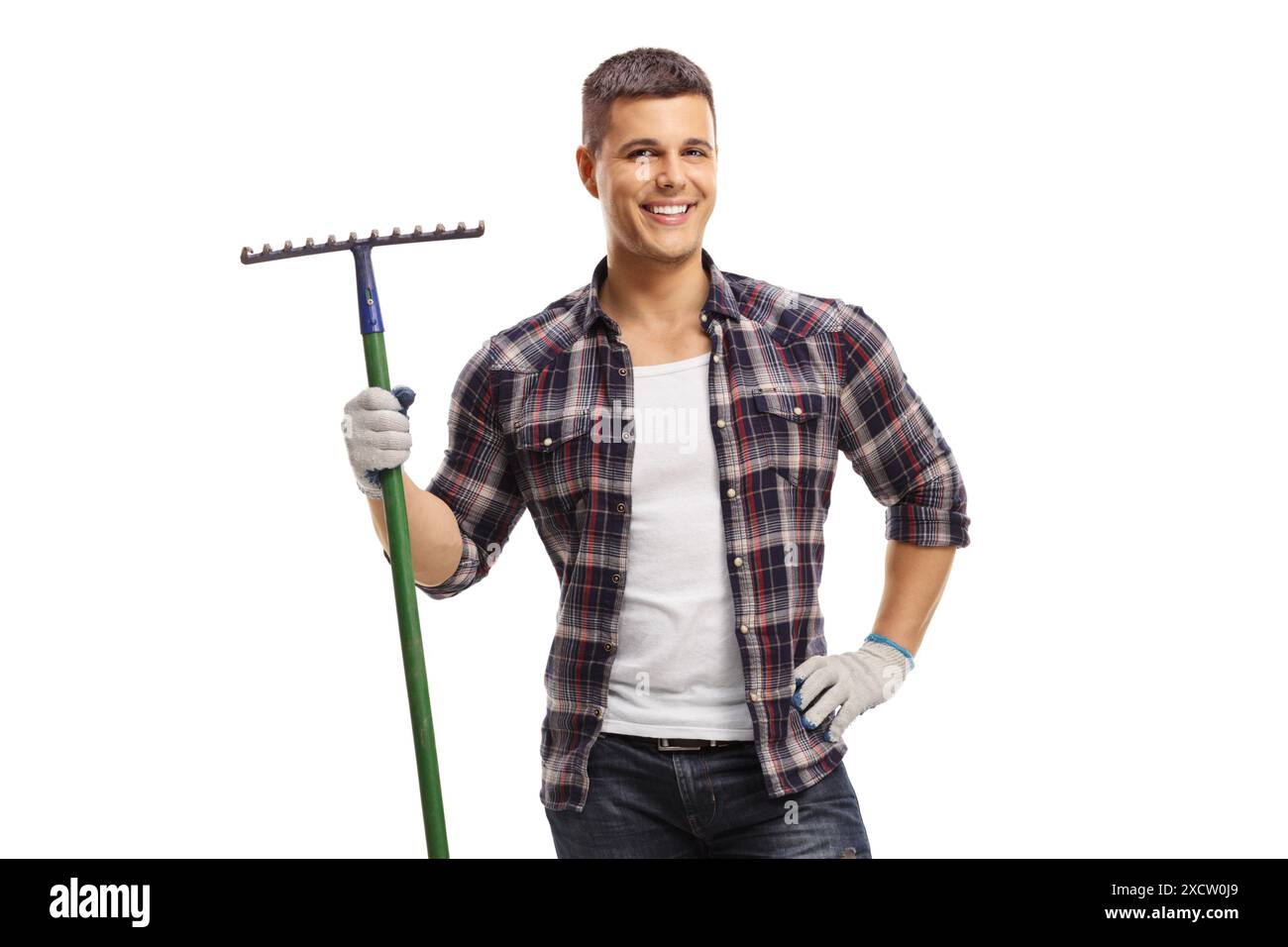 Cheerful young farmer holding a rake isolated on white background Stock ...