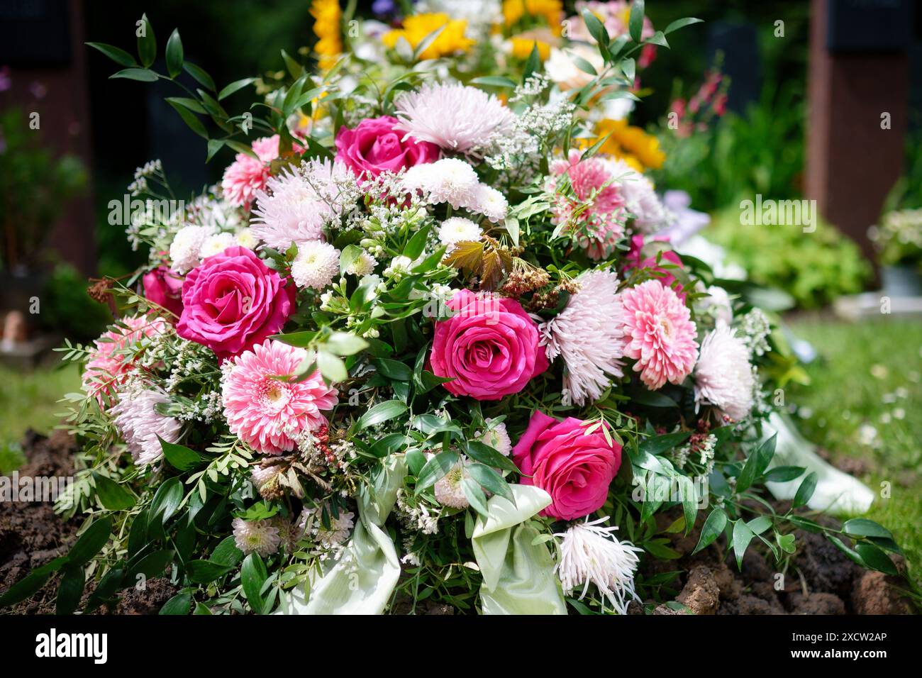 Vibrant flowers on fresh grave, symbolizing love and remembrance post ...