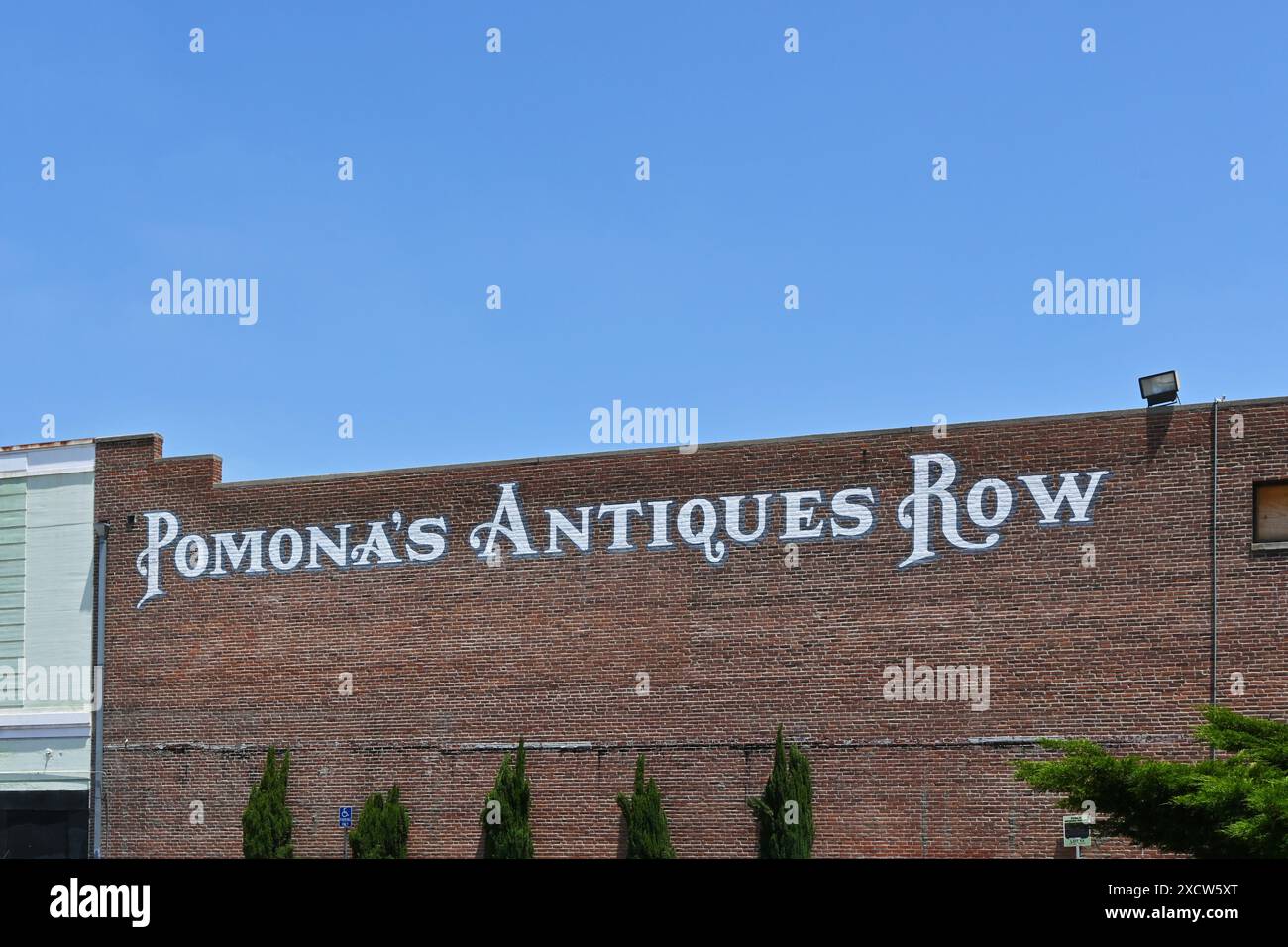 POMONA, CALIFORNIA - 18 MAY 2024: Pomonas Antique Row sign on a brick ...