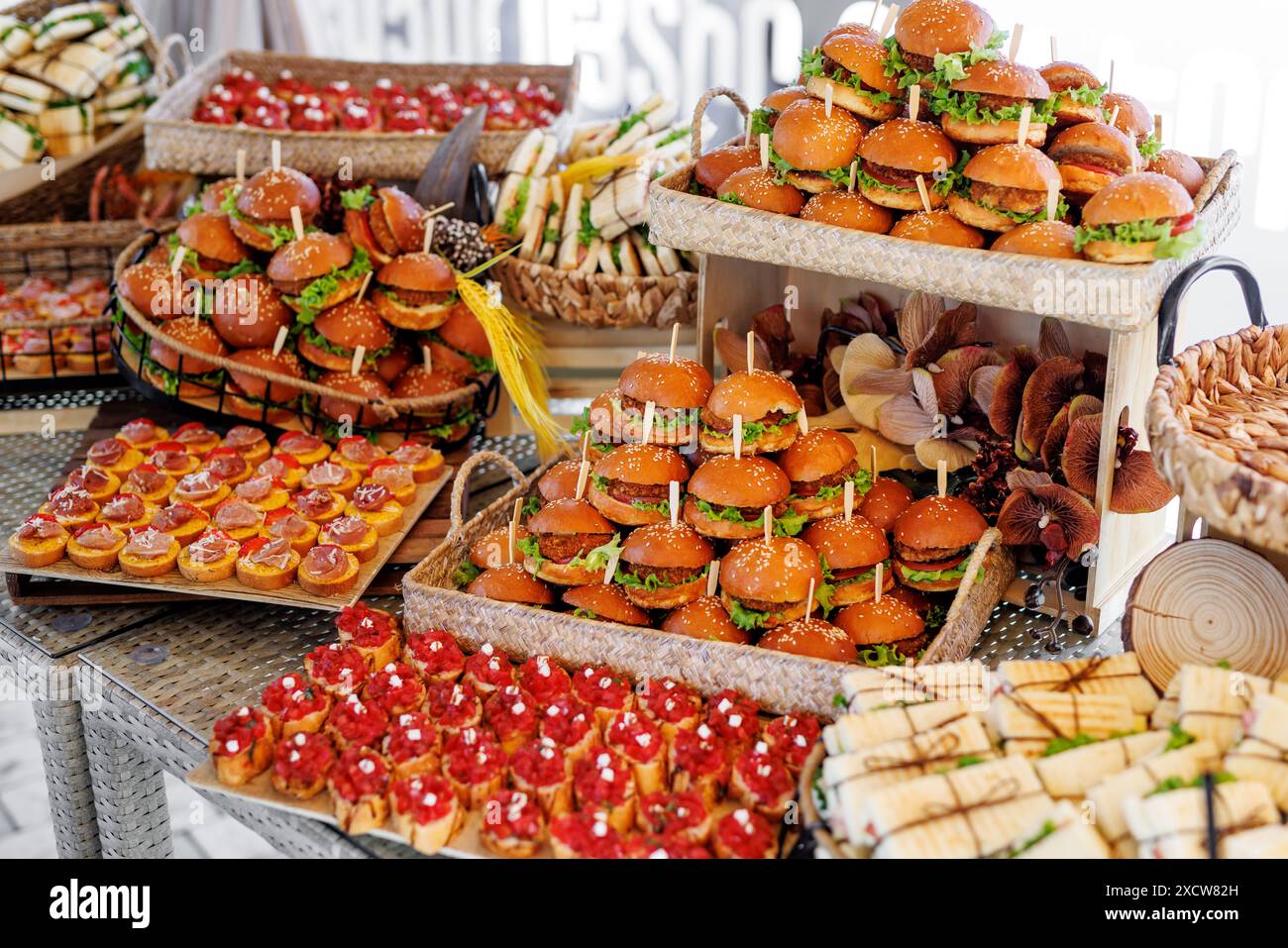 Mini burgers and other snacks served on the tray. Buffet or event ...