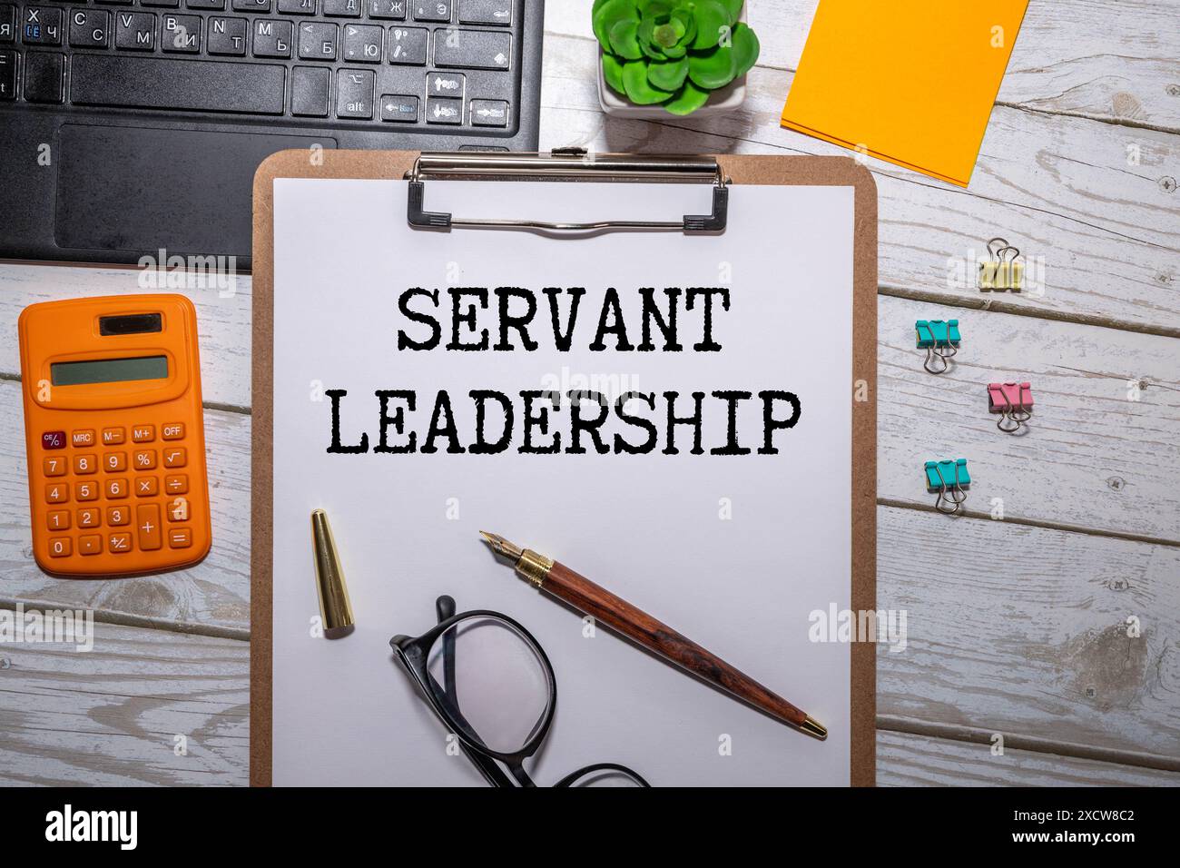 Servant leadership - wooden letters and note on bright background Stock ...