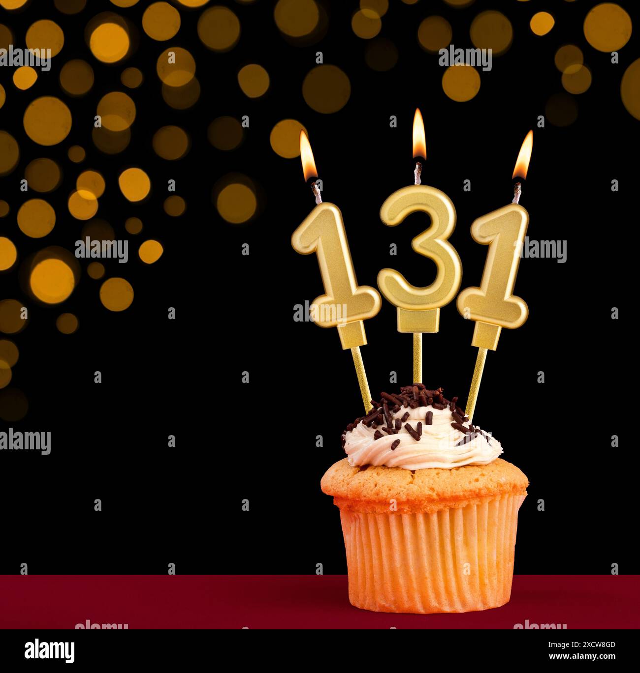 Number 131 birthday candle - Cupcake on black background with out of ...