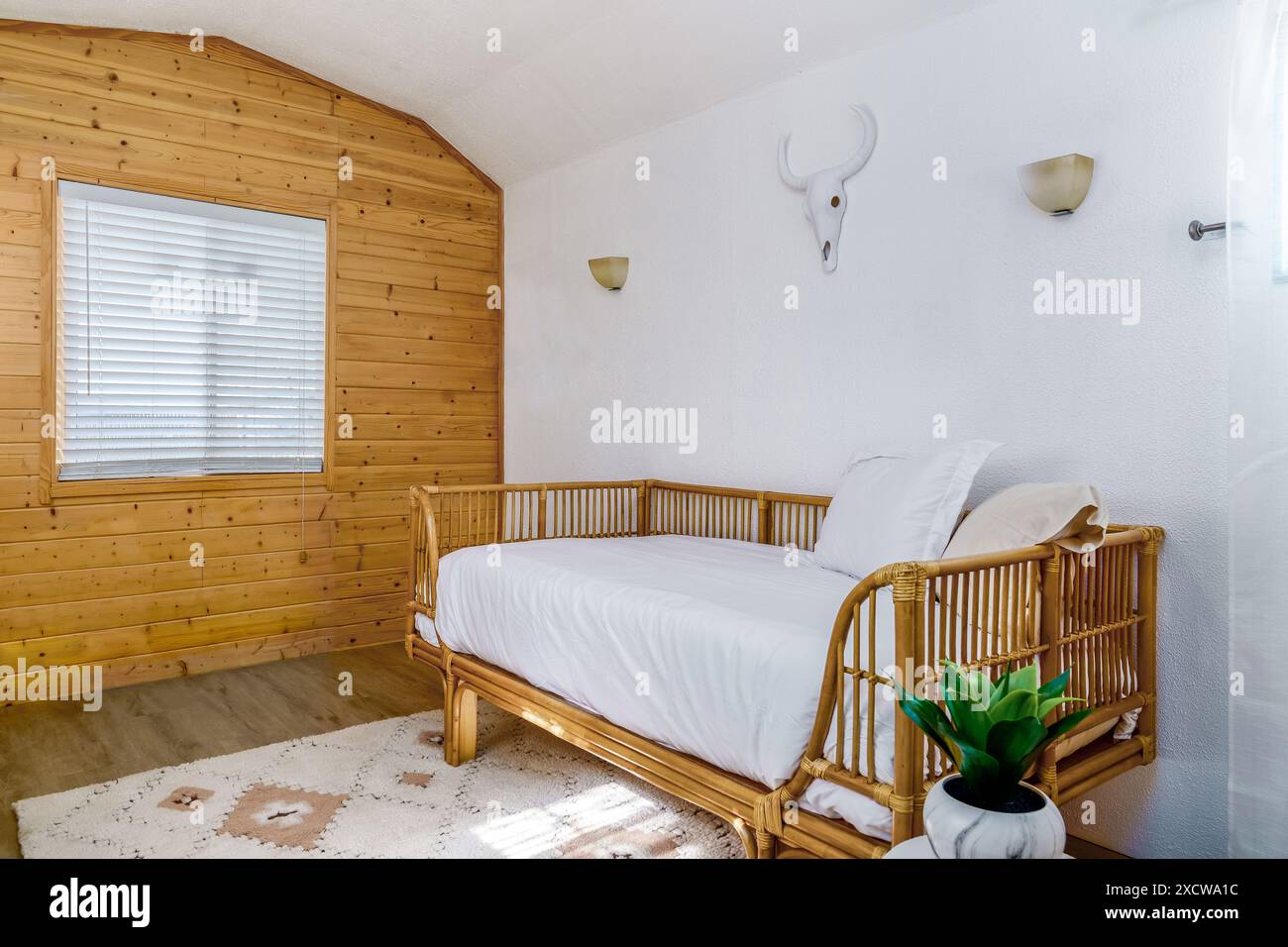 Rattan daybed boho cabin bungalow casita knotty pine paneling Stock ...