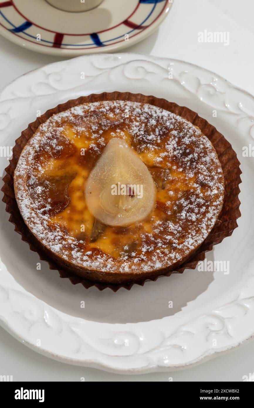 Homemade baked pear cake with caramel almond custard close up ...