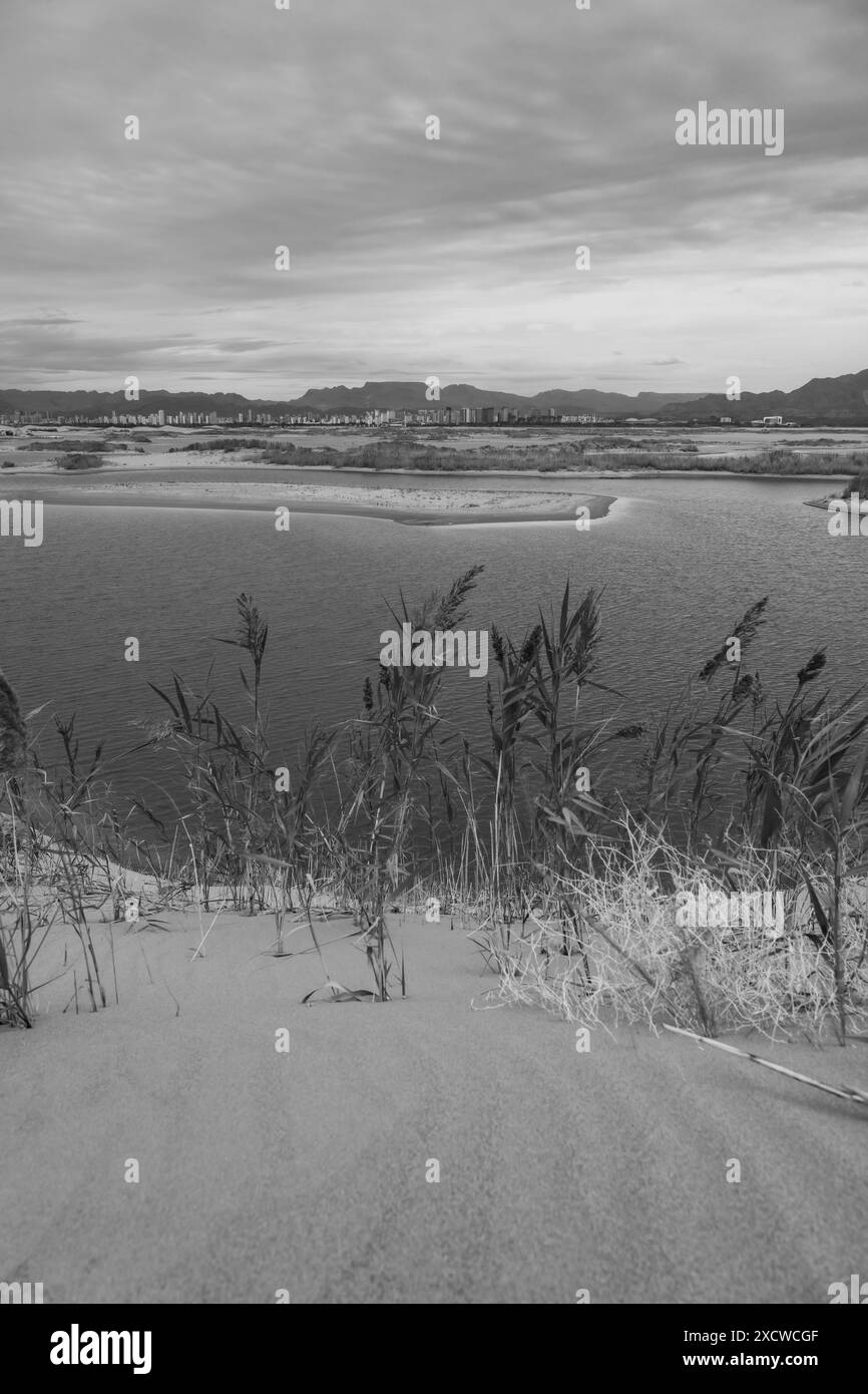 Desert vastness next to lake in Wuhai, Inner Mongolia, China. Dramatic ...