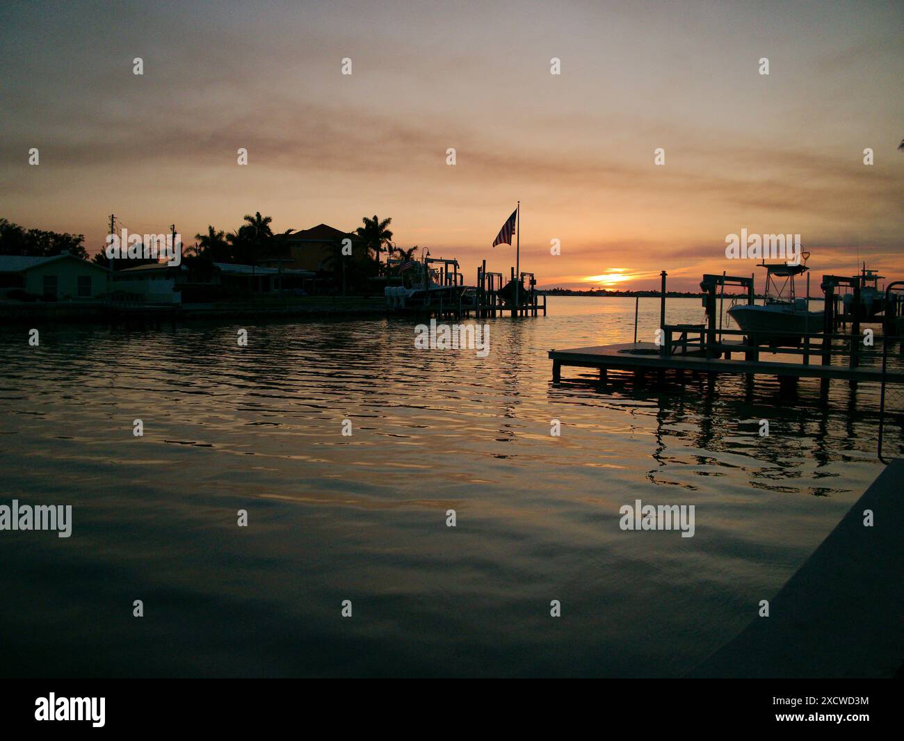 Sunset Silhouette of US Flag looking NW Boca Ciega Bay near bridge at ...