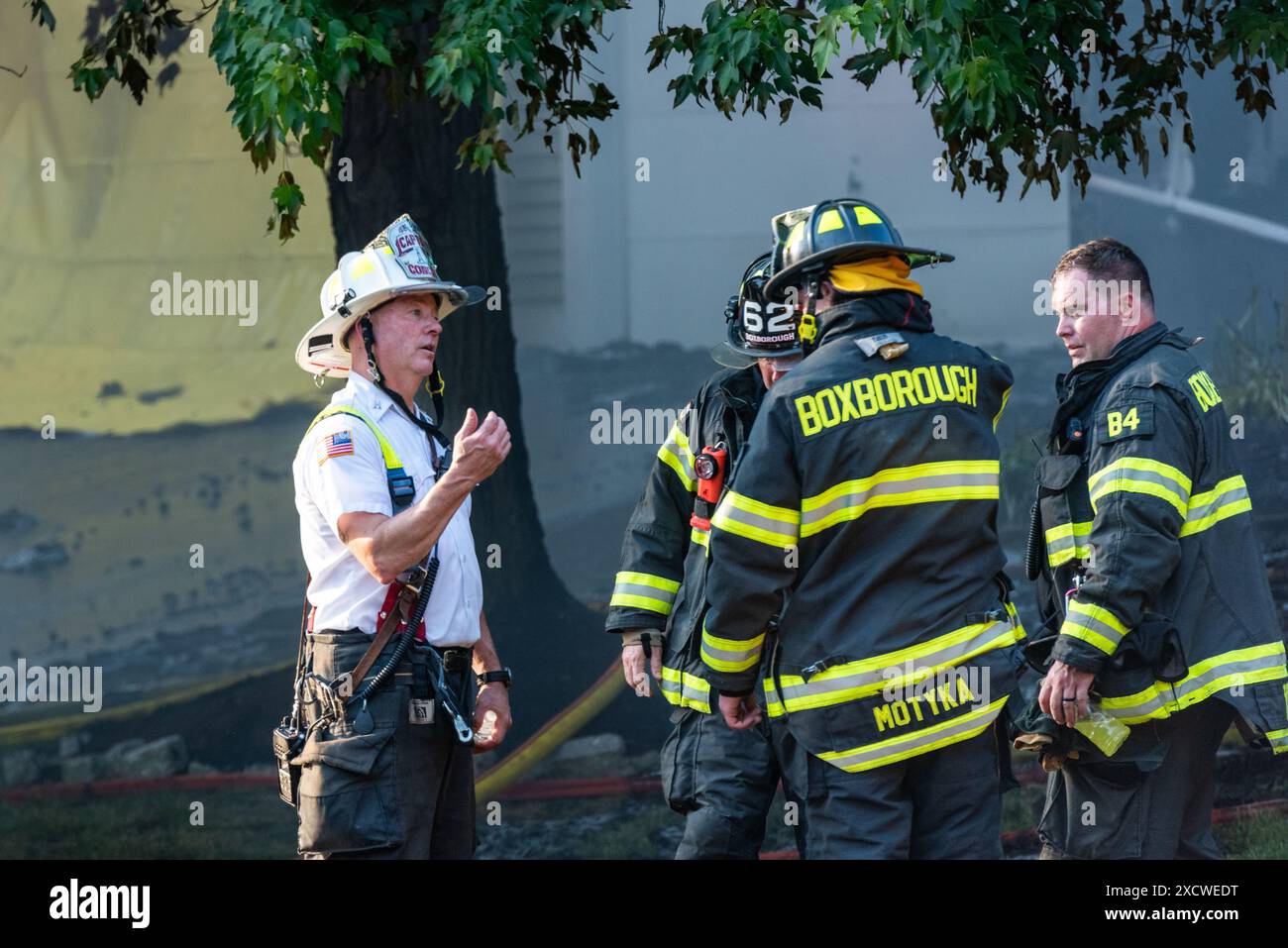 Concord Fire Captain Sean Murphy in discussion with firefighters at a ...