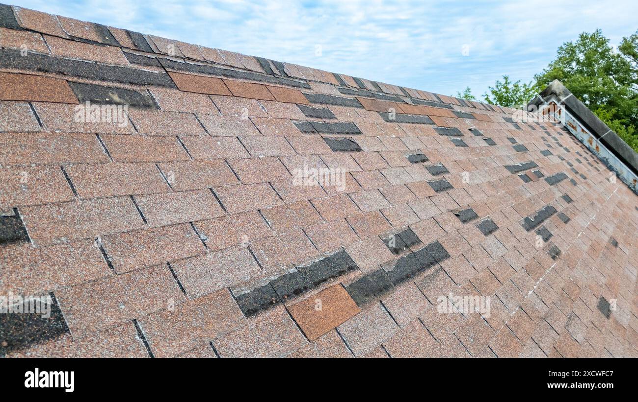 Roof in need of repair, missing shingles from storm damage Stock Photo ...
