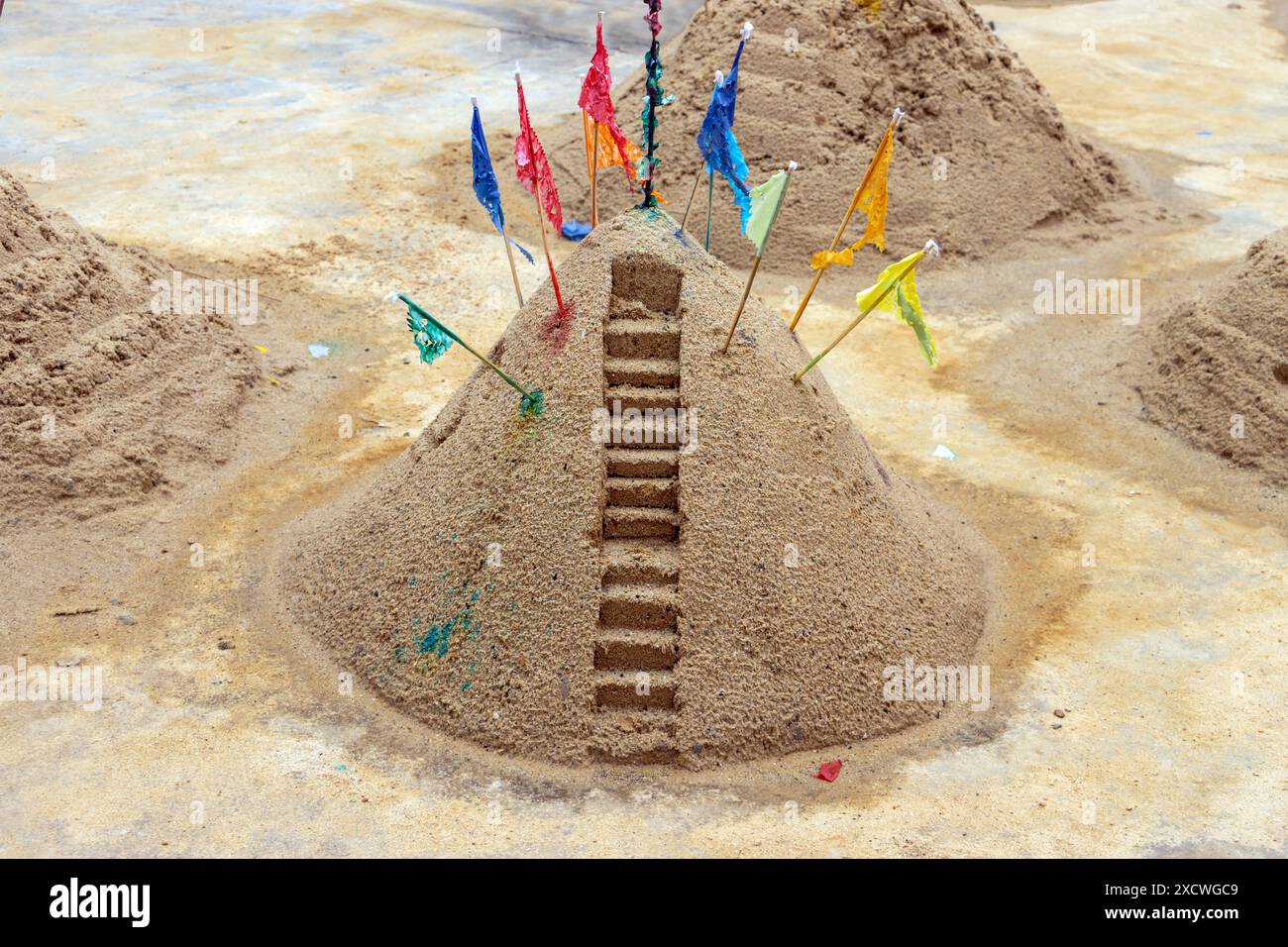 Piles of sand ready to create sand buildings at a traditional festival ...