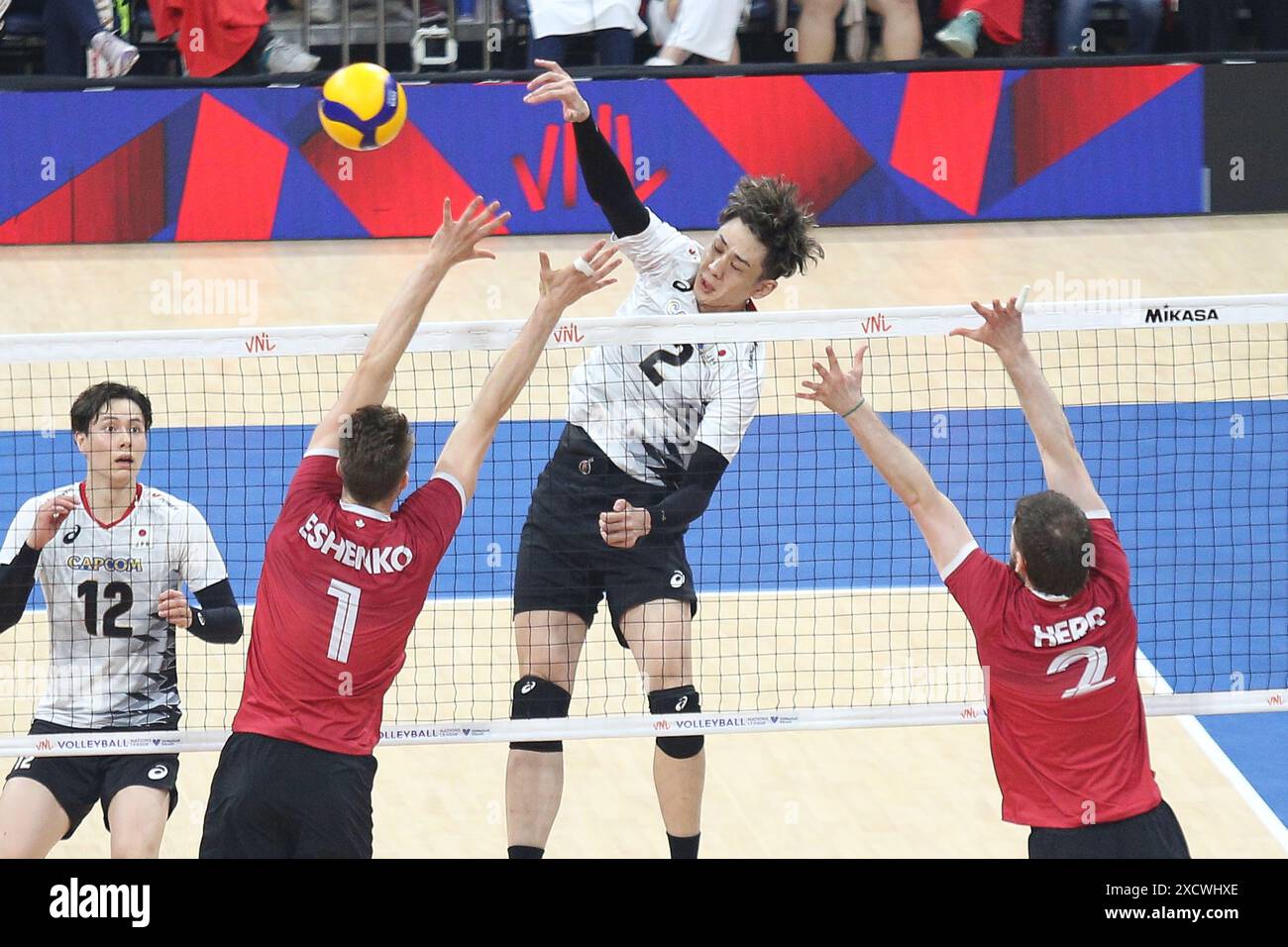 Taishi Onodera [2, White] of Japan spikes the ball over Pearson Eshenko ...