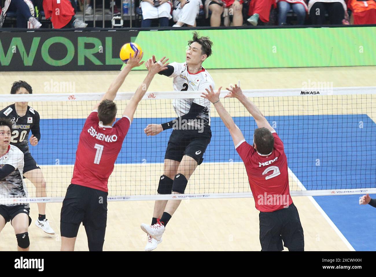 Taishi Onodera [2, White] of Japan spikes the ball over Pearson Eshenko ...