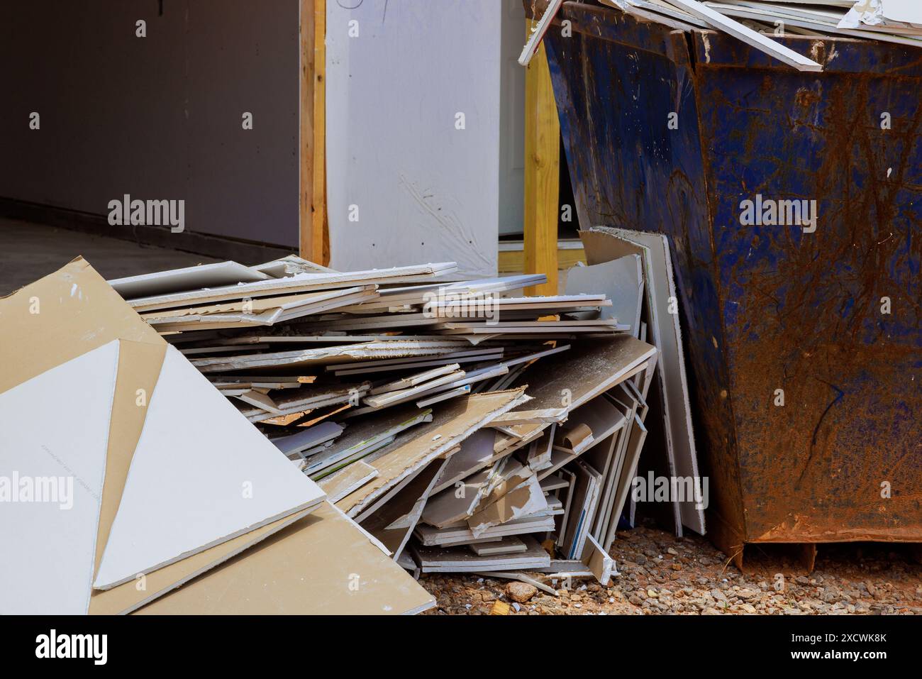 Drywall pieces disposed of in container for construction waste with ...