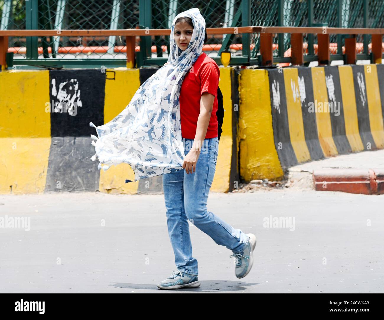 NOIDA, INDIA - JUNE 18: Commuters cover their heads to escape the heat ...