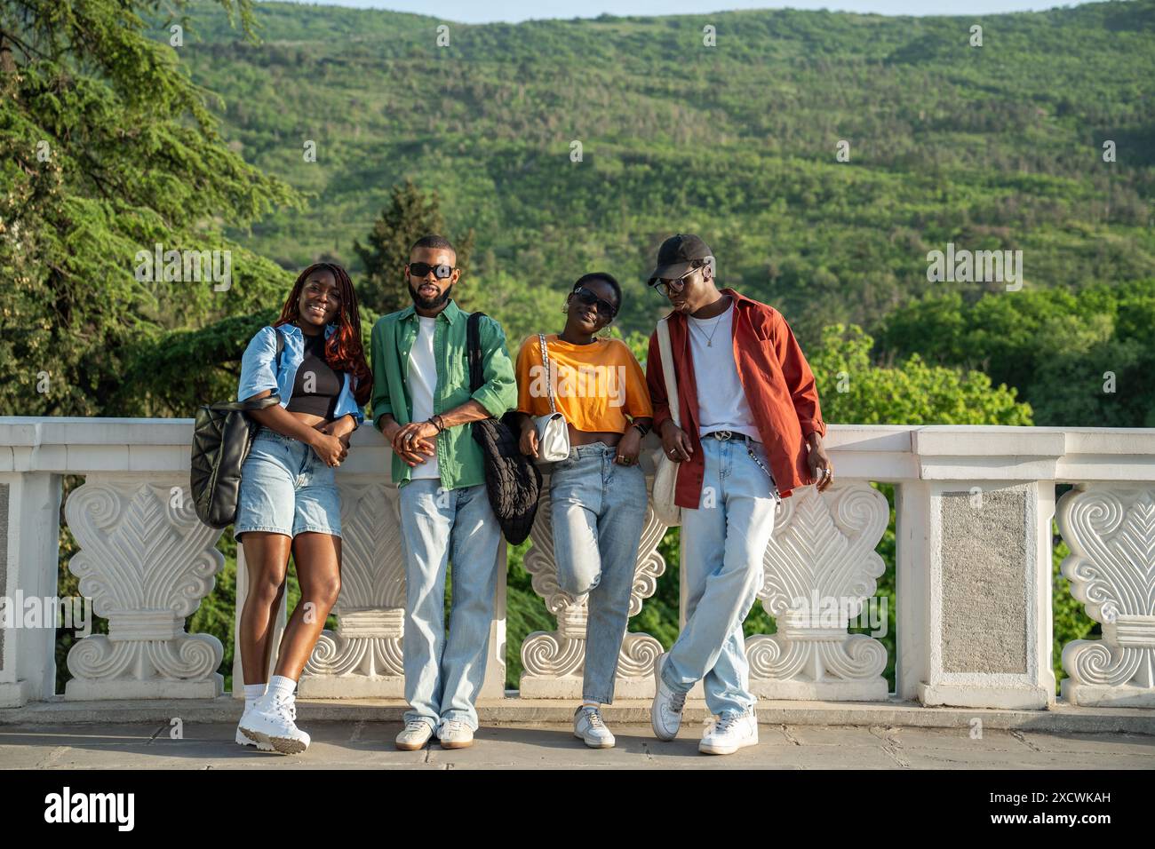 Friendly company of contented black African classmates buddies enjoying ...
