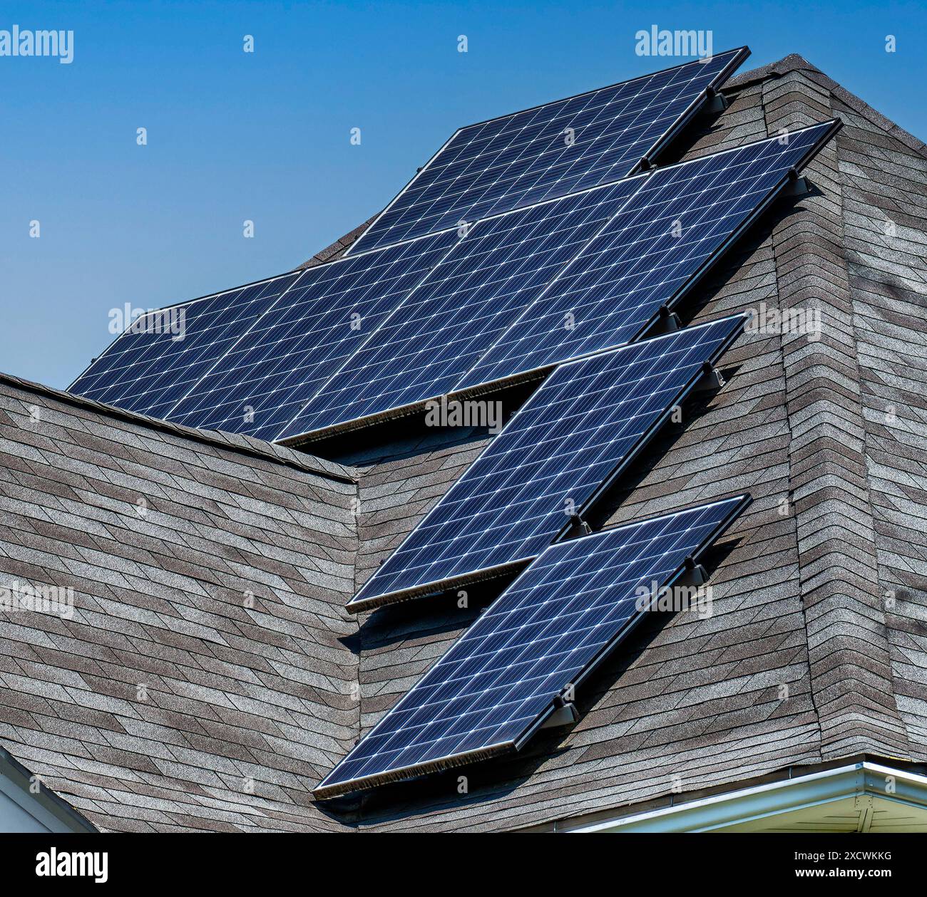 Solar panels arranged on a high pitched roof with several sides Stock ...
