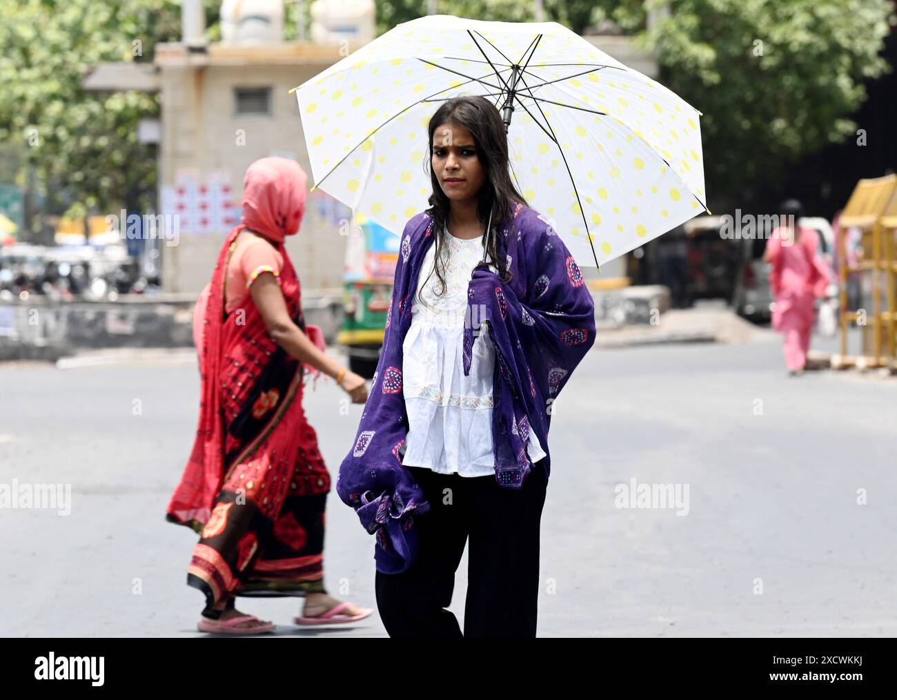 NOIDA, INDIA - JUNE 18: Commuters cover their heads to escape the heat ...