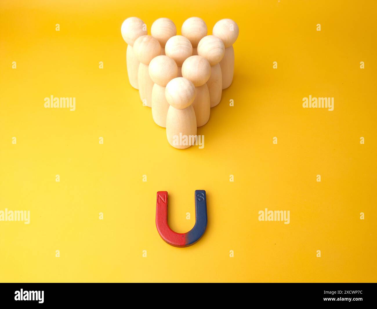 Wooden figures of people and a magnet. Team management concept. Human ...