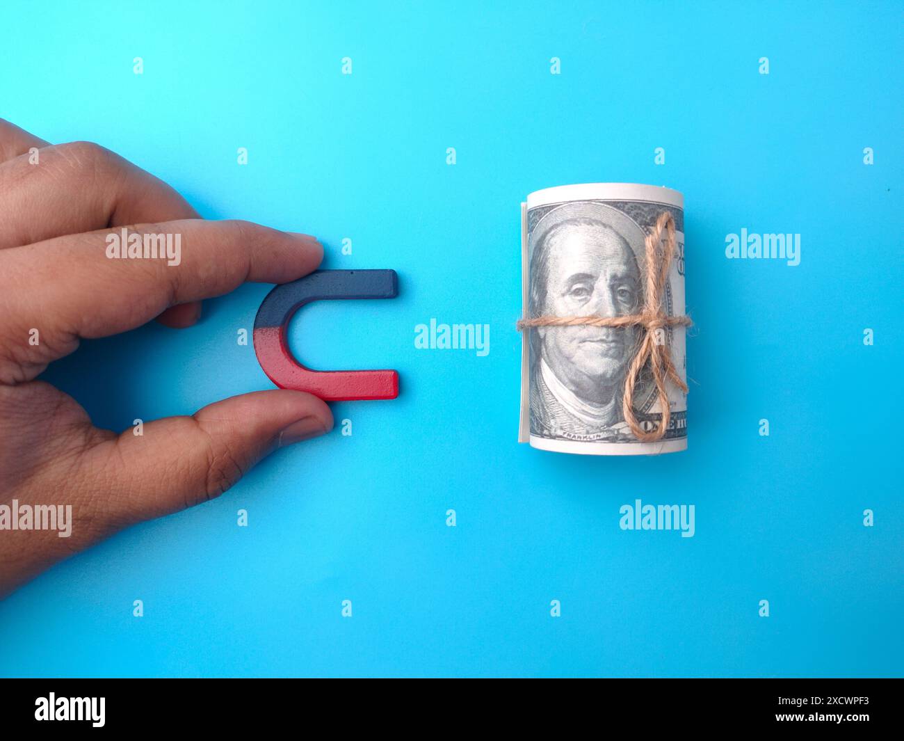 Hand holding magnet investment attraction hi-res stock photography and ...