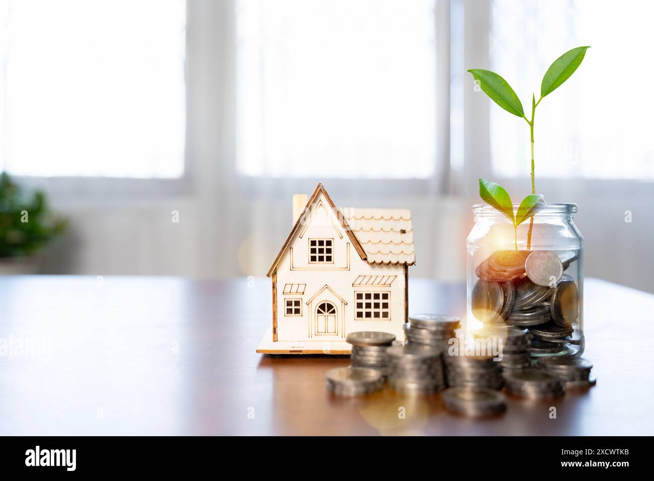 Saving money for future concept. House with gold coins currency in ...