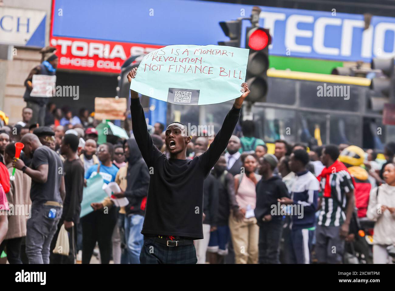 Nairobi, Kenya. 18th June, 2024. A Protester holds a placard during a ...