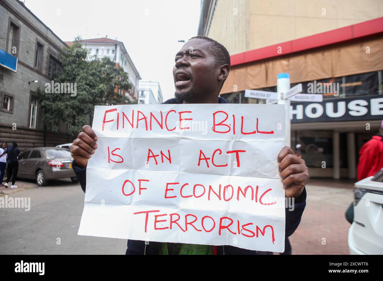 Nairobi, Kenya. 18th June, 2024. A Protester holds a placard during a ...