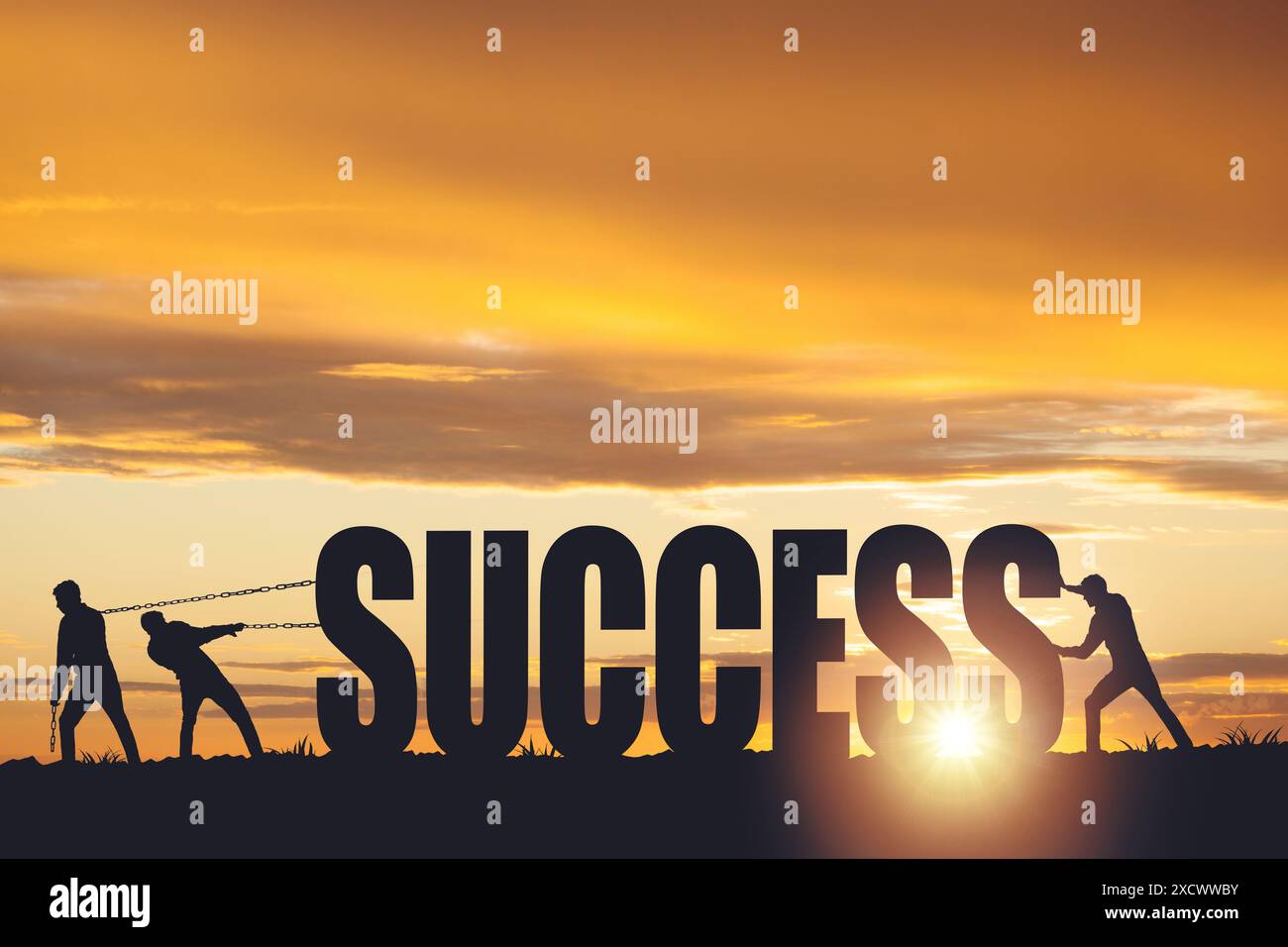 Silhouettes of people drawing the word SUCCESS on a sunset background ...