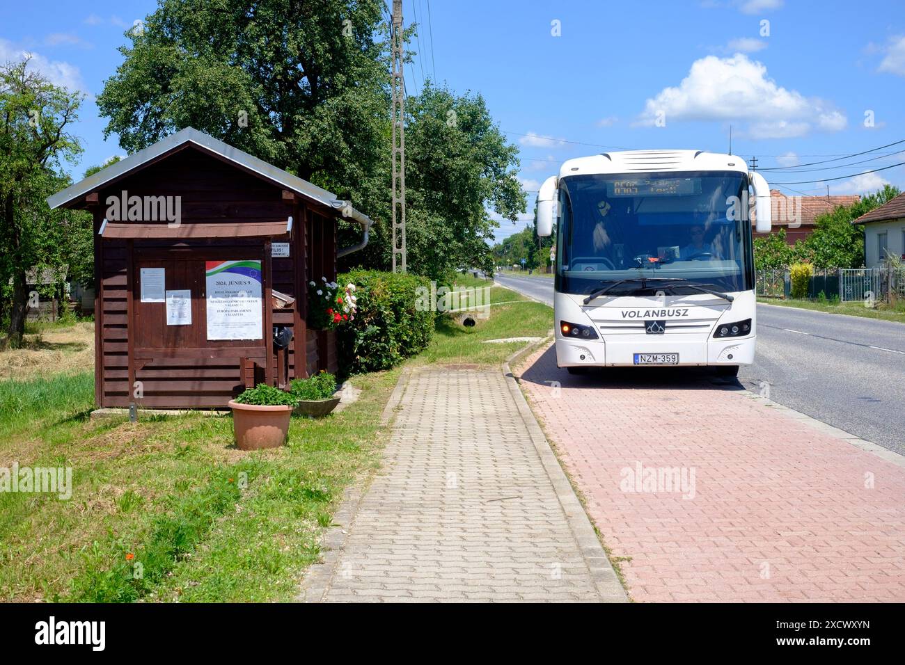 hungarian local volanbusz bus pulling into rural village bus stop zala ...