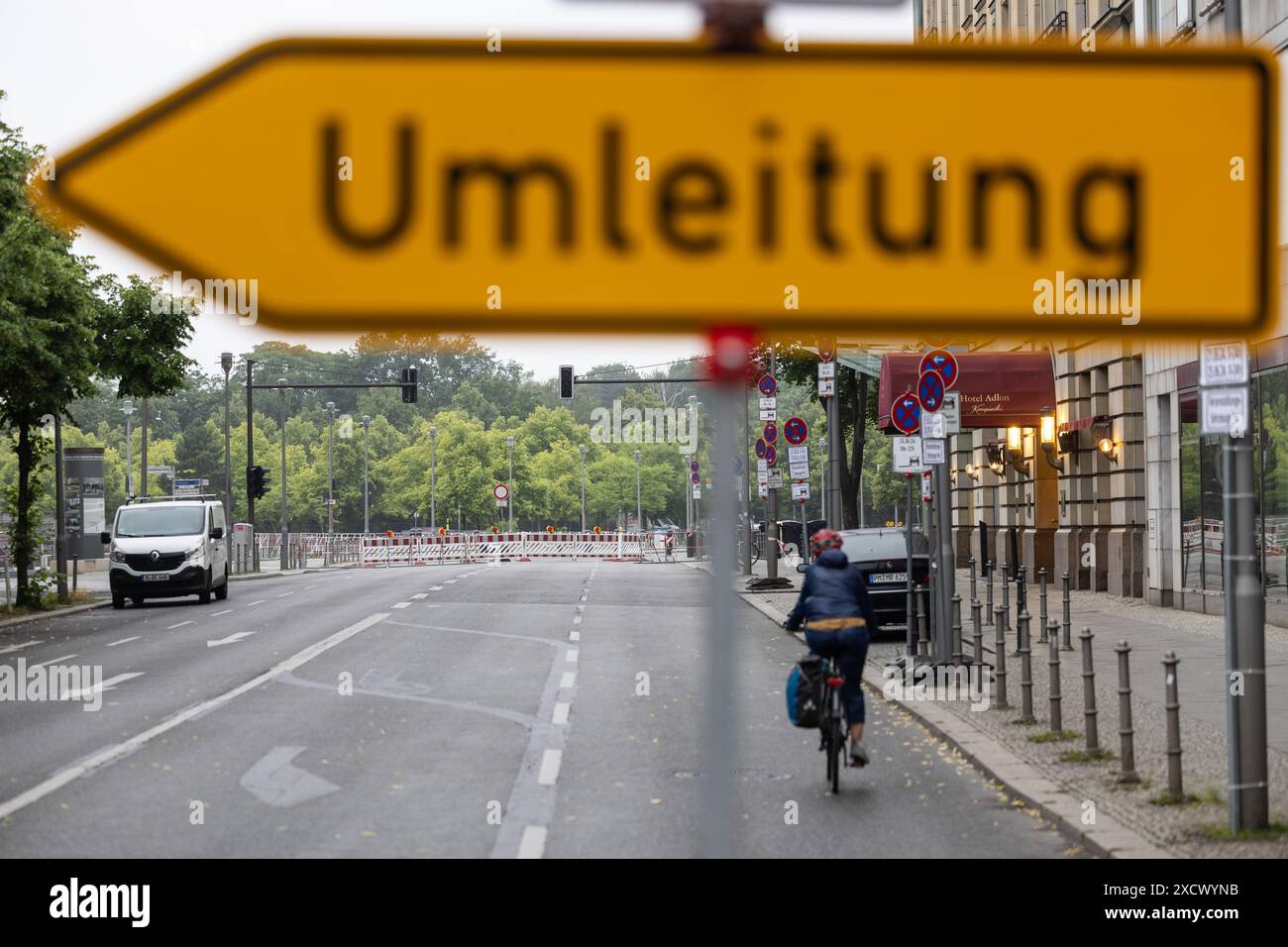 Berlin, Germany. 19th June, 2024. A cyclist is riding behind a detour ...